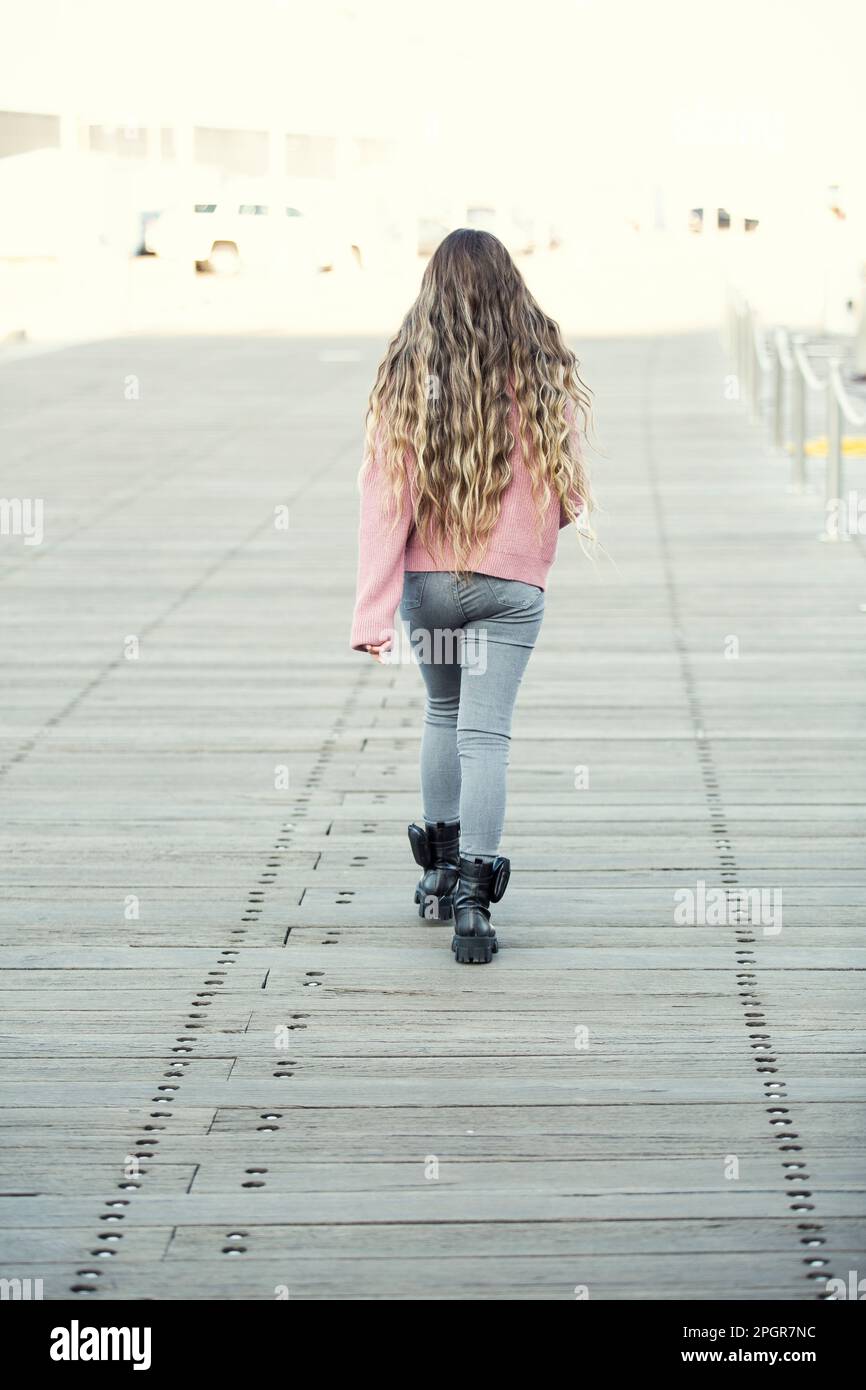 Girl walking away outdoors Stock Photo - Alamy
