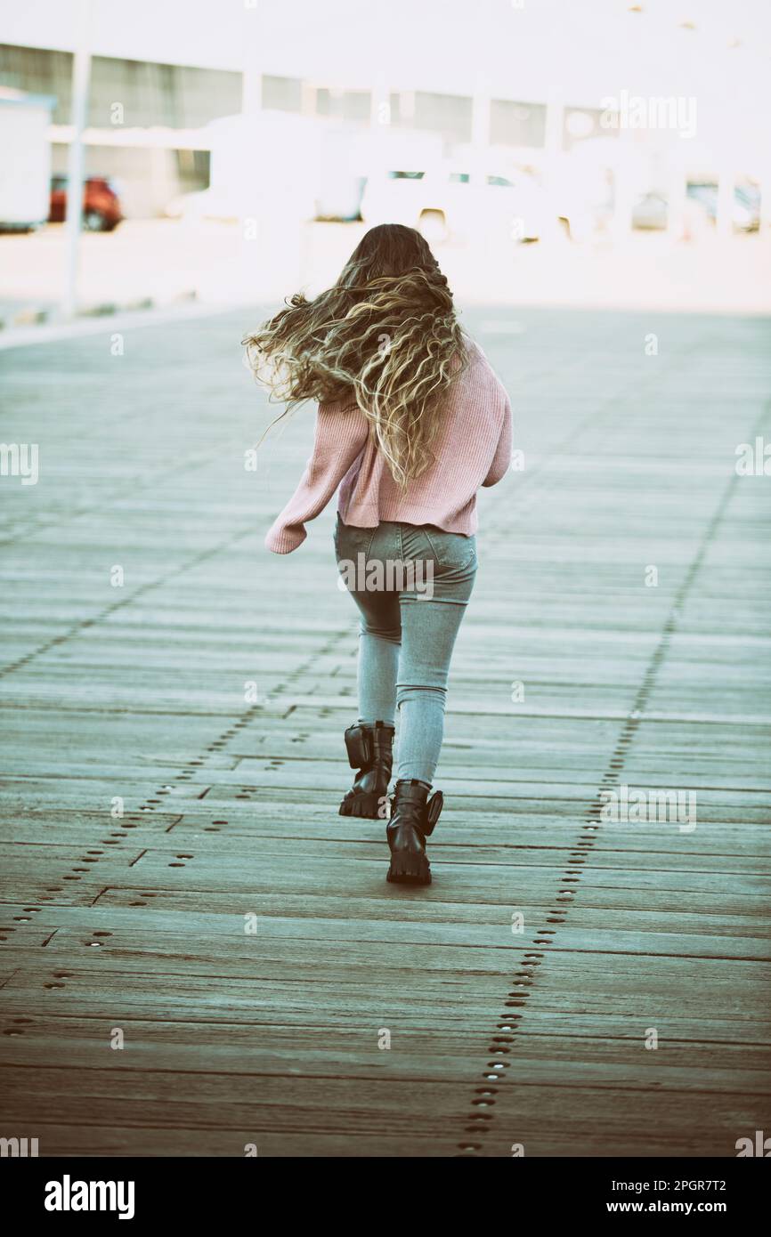 Rear view girl running away outdoors Stock Photo - Alamy