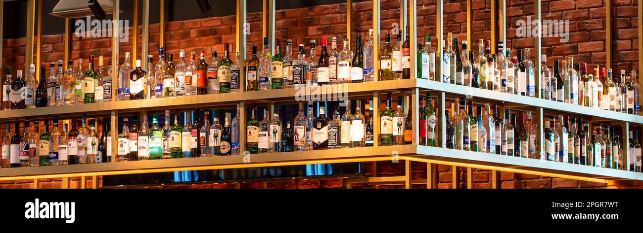 The Bottles Of Alcohol And Spirits On Backlight Shelves At A Pub Or Bar ...