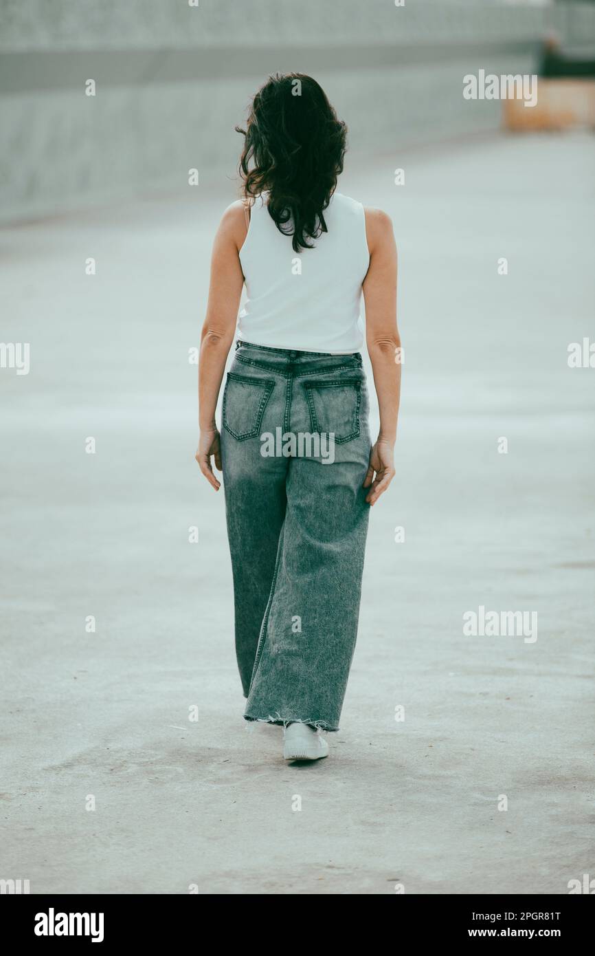 Woman walking away outdoors Stock Photo - Alamy