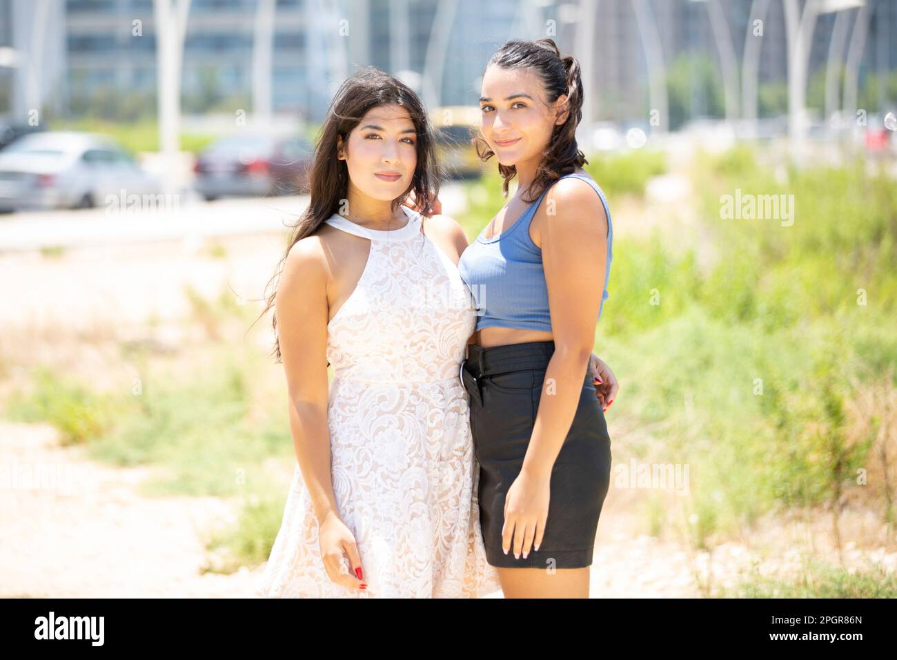 Beautiful young women looking at camera outdoors smiling Stock Photo ...