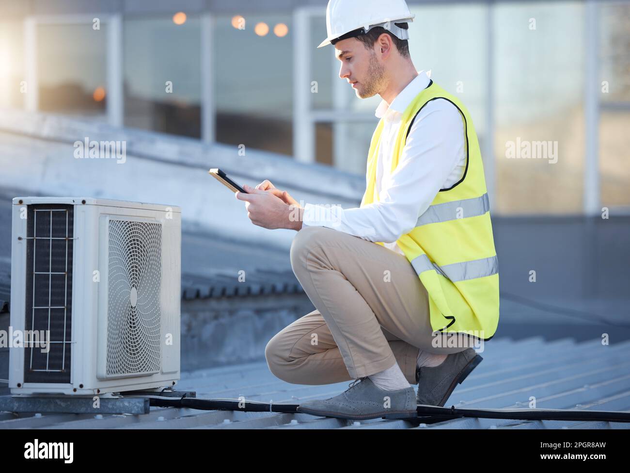 Man, engineer and tablet on roof for air conditioning maintenance, tech ...