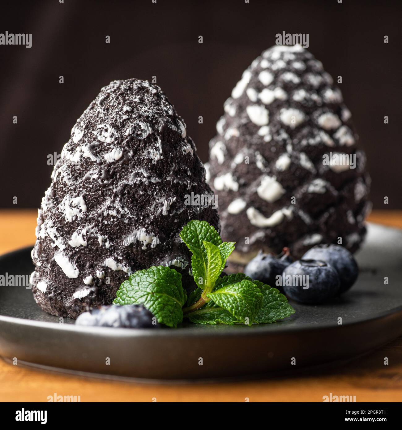Mini-mousse dessert in the form of a pine cone, covered with velor ...