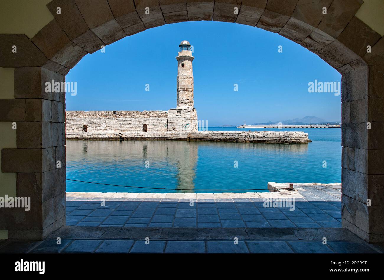 Historic Rethymon lighthouse framed by one of the buildings located on ...