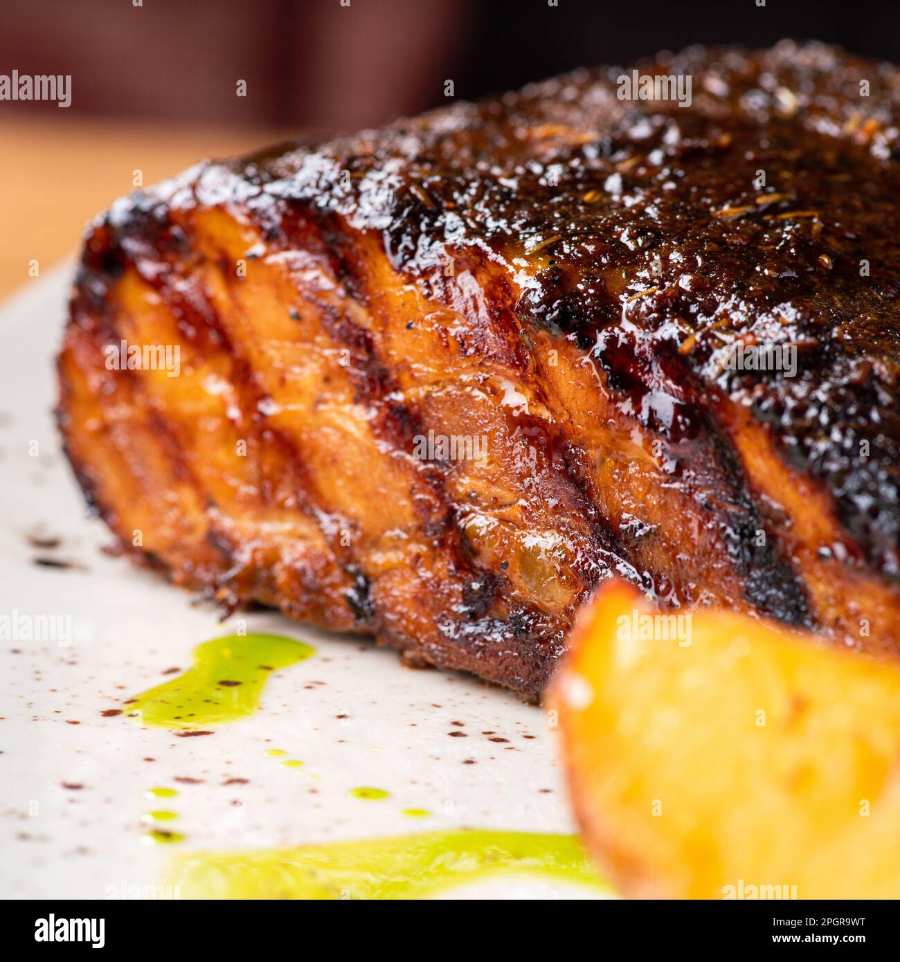 Close up Gourmet Main Dish with Grilled Pork Rib and Fried Potatoes on ...