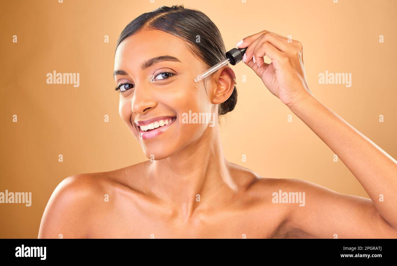 Face portrait, skincare serum and woman in studio isolated on brown ...