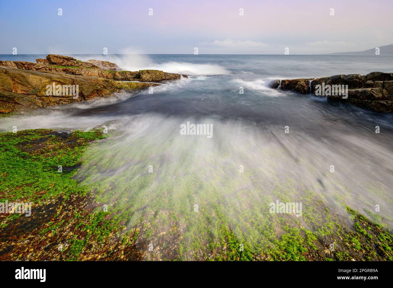 White waves wash over mossy brown rocks. Explore breathtaking coastal ...