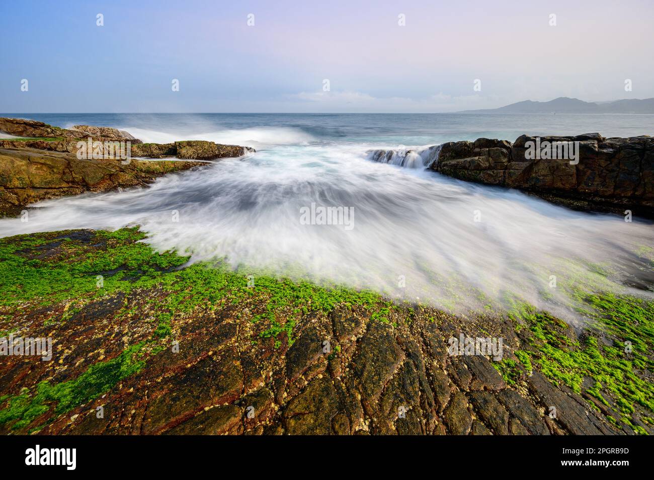 White waves wash over mossy brown rocks. Explore breathtaking coastal ...