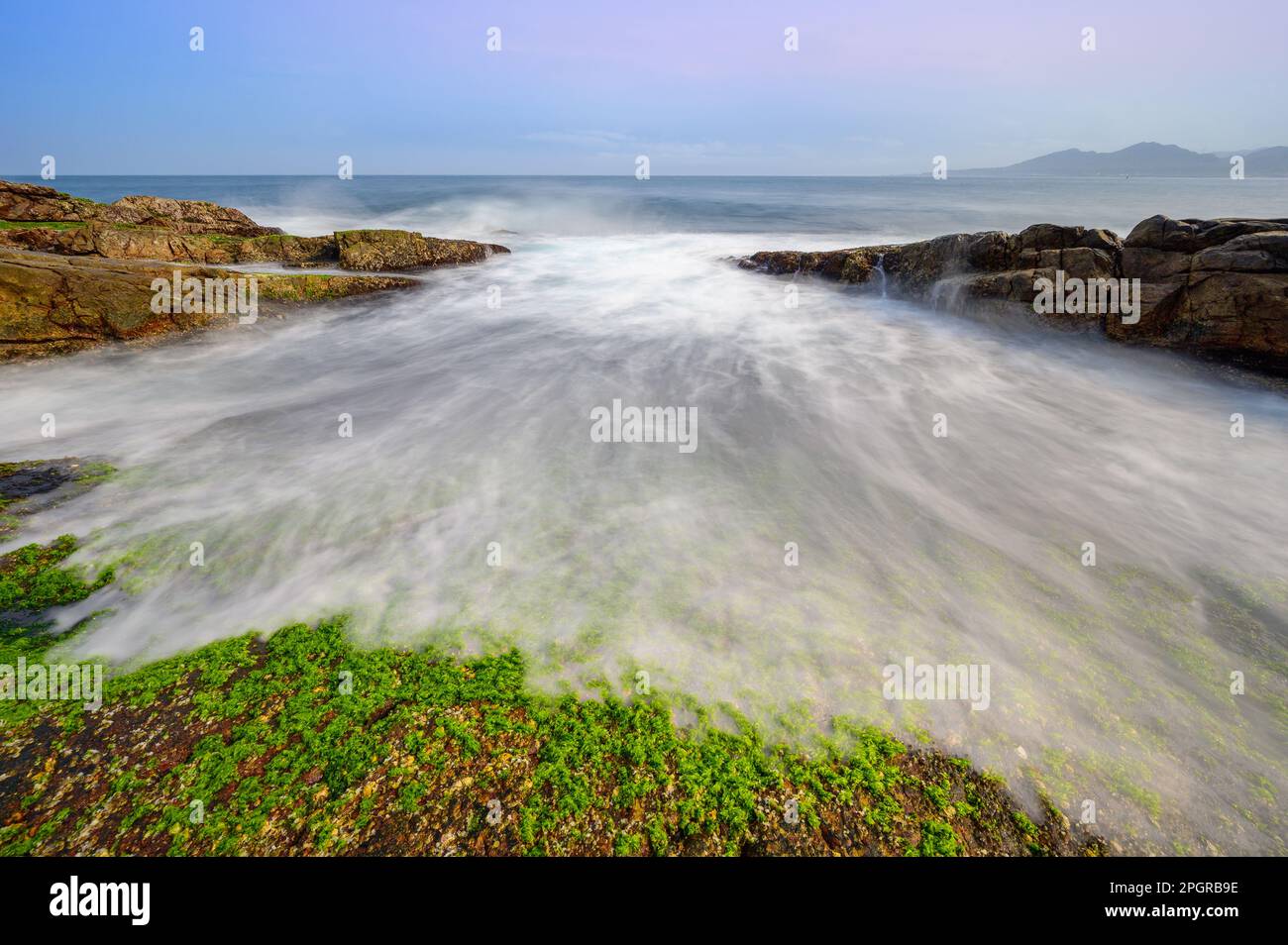 White waves wash over mossy brown rocks. Explore breathtaking coastal ...