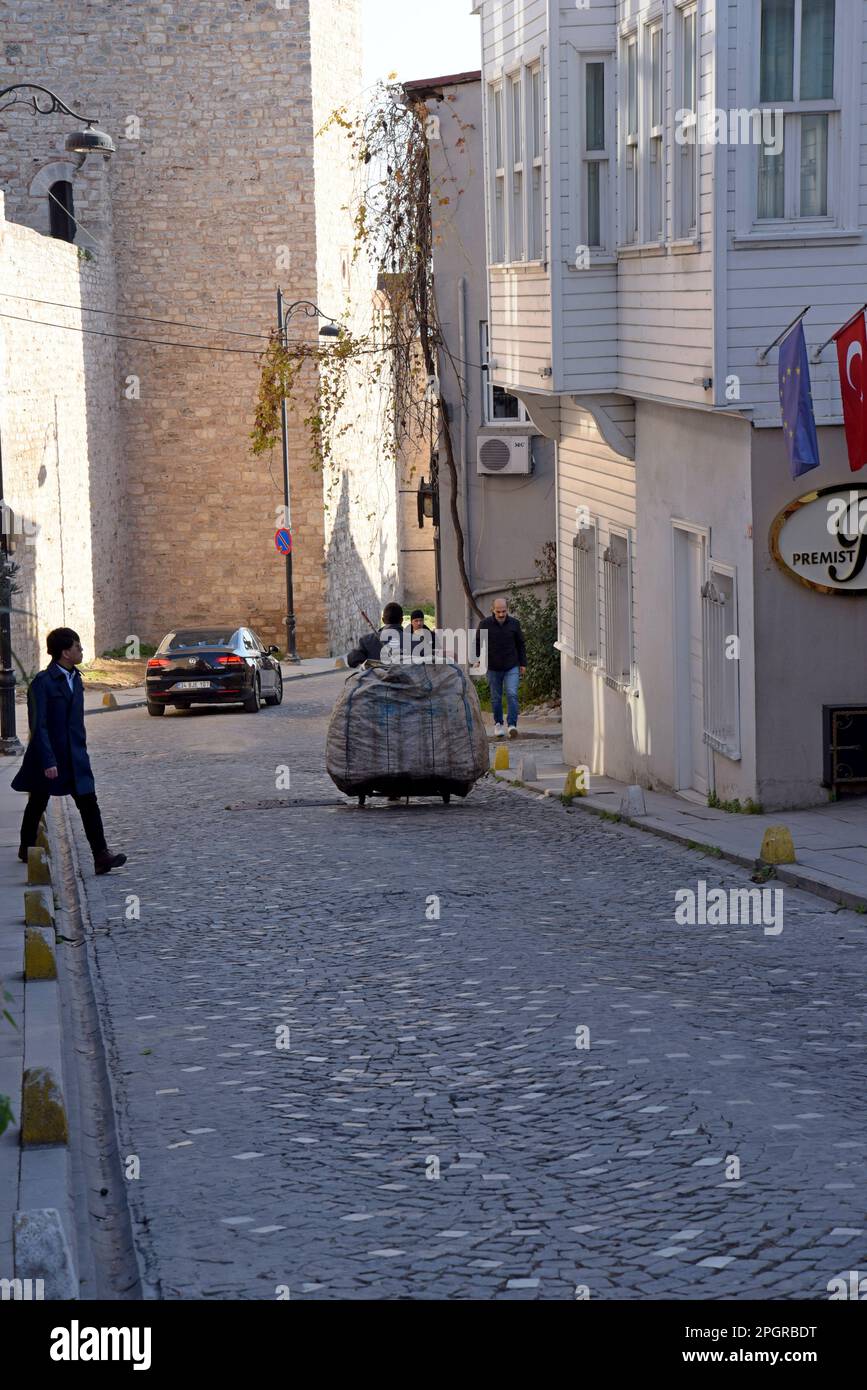 Workers pulling handcarts to collect garbage & recycling on the streets ...