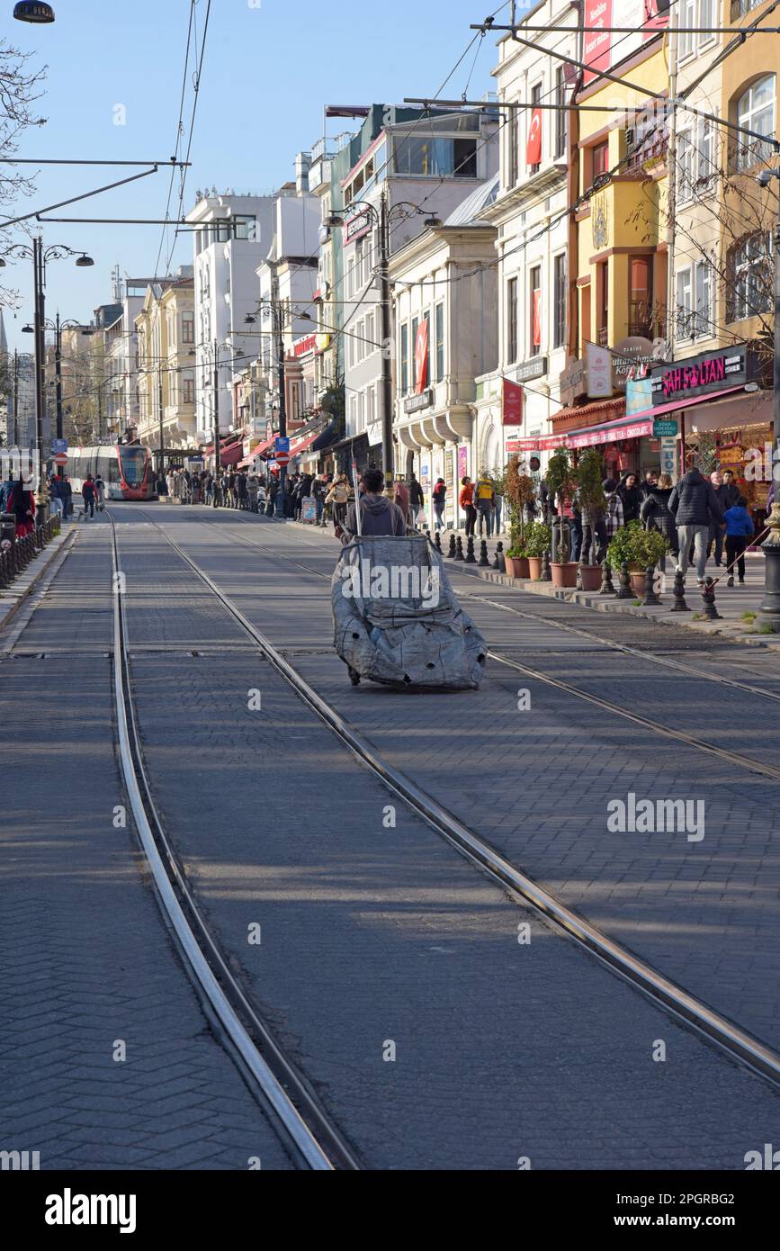 Workers pulling handcarts to collect garbage & recycling on the streets ...