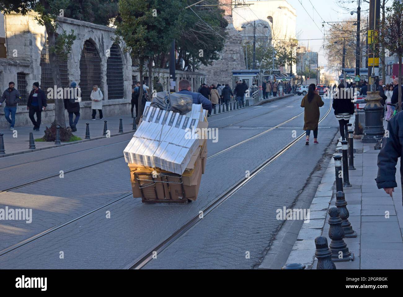 Parcel delivery workers using hand carts to deliver large packages on ...