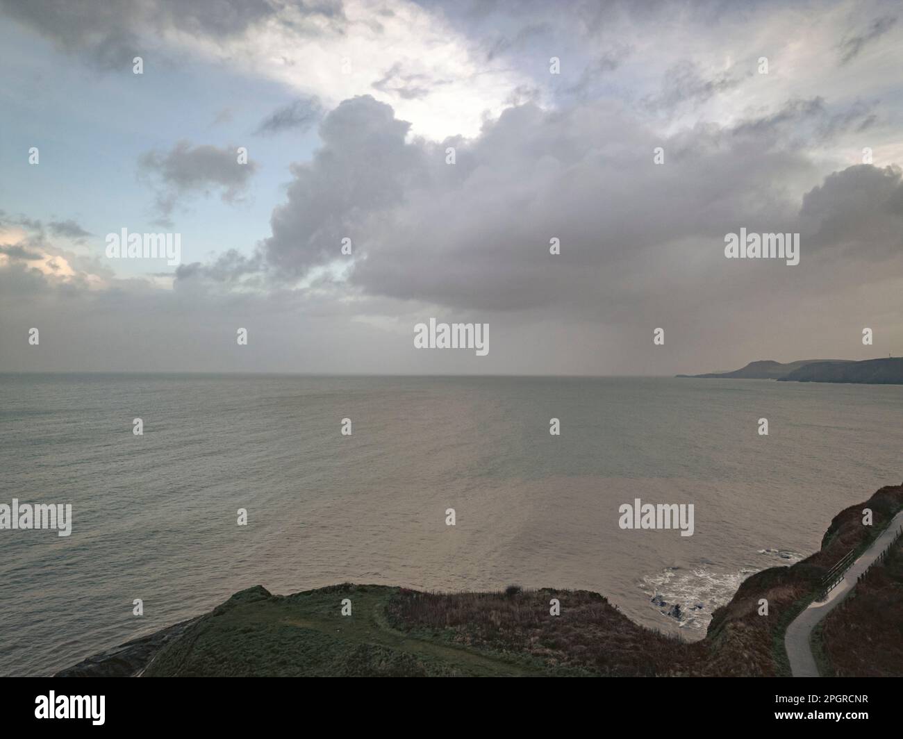 Clouds and rain over the ocean along the Welsh coastal path and ...