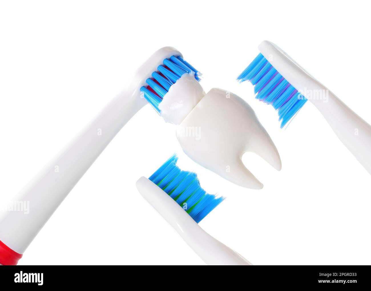 Three electric toothbrushes cleaning a tooth model in a close-up view ...