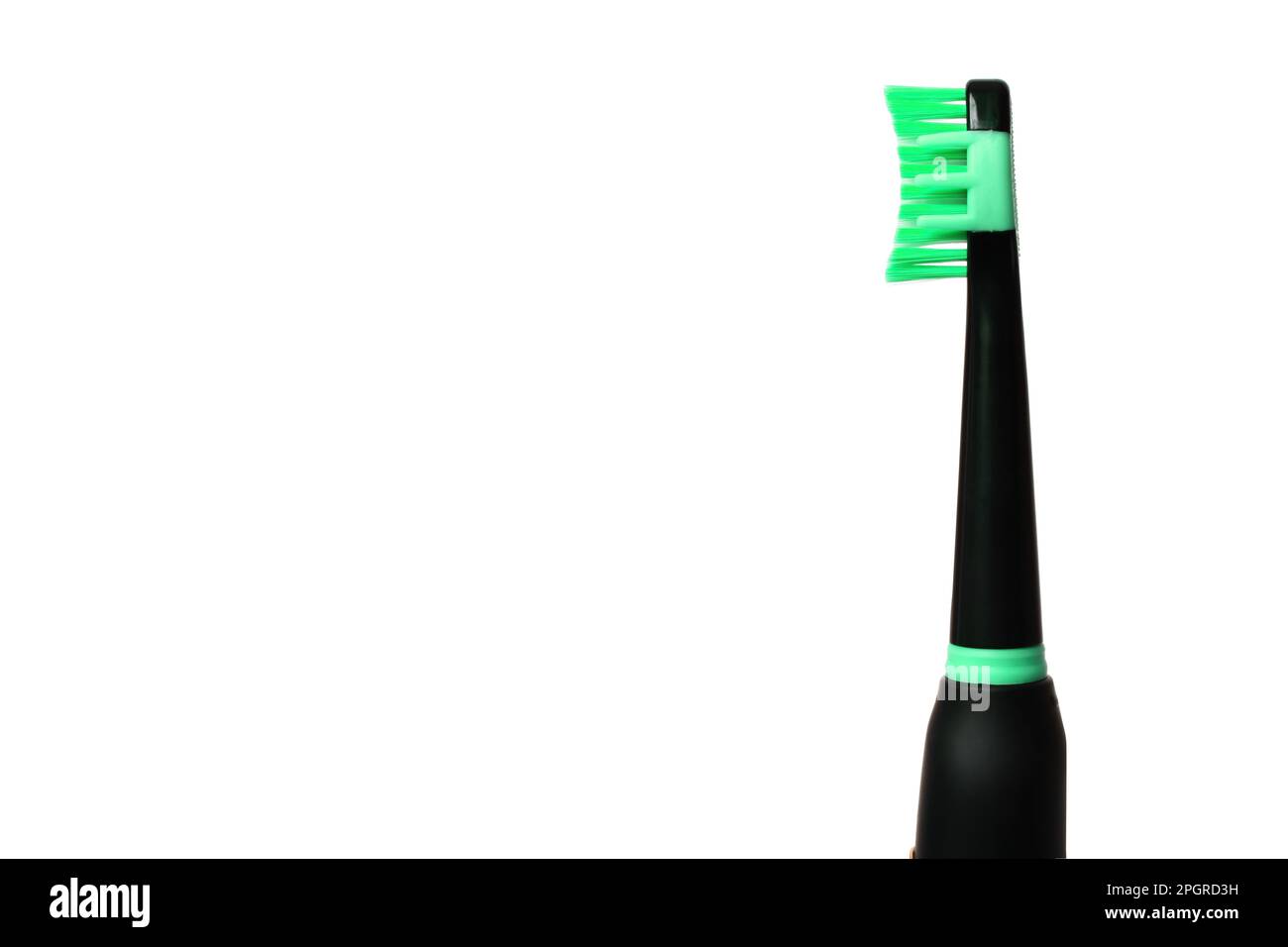 Close-up view of a black electric toothbrush with green elements and ...