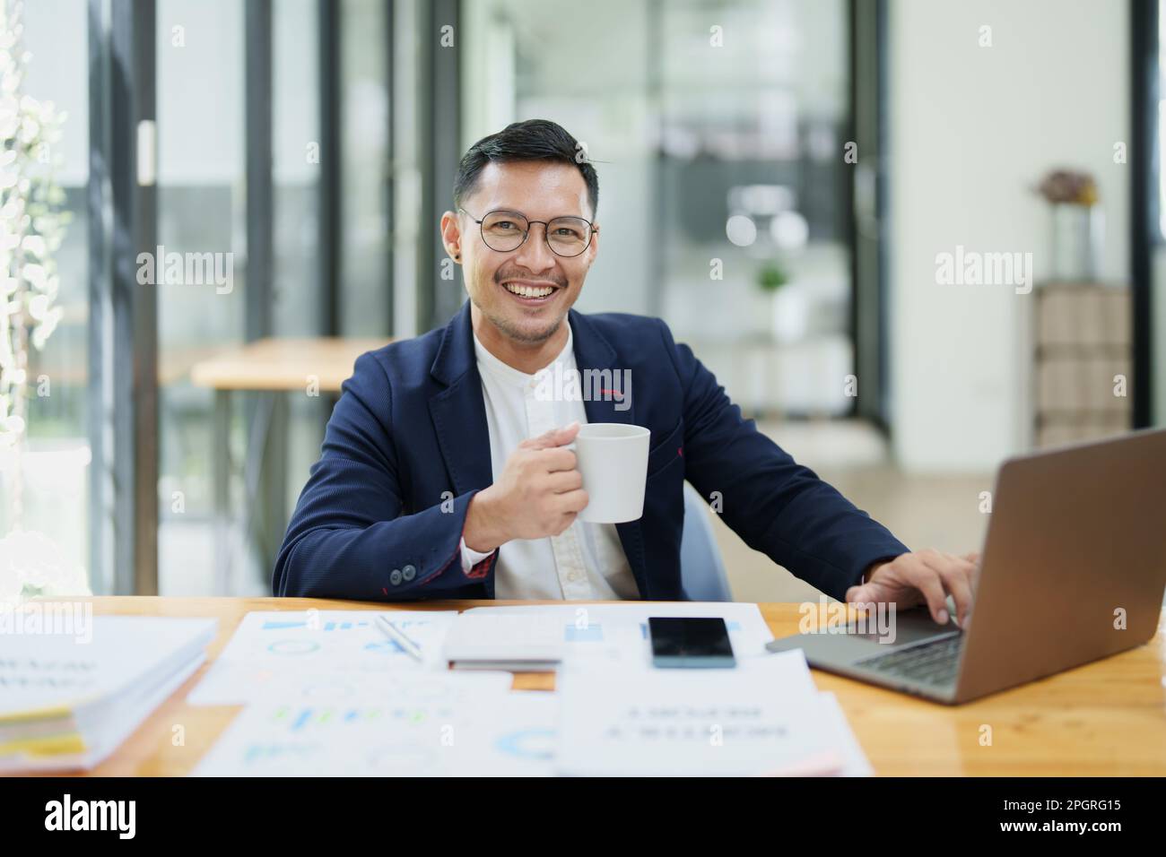 Portrait of a male business owner showing a happy smiling face as he ...