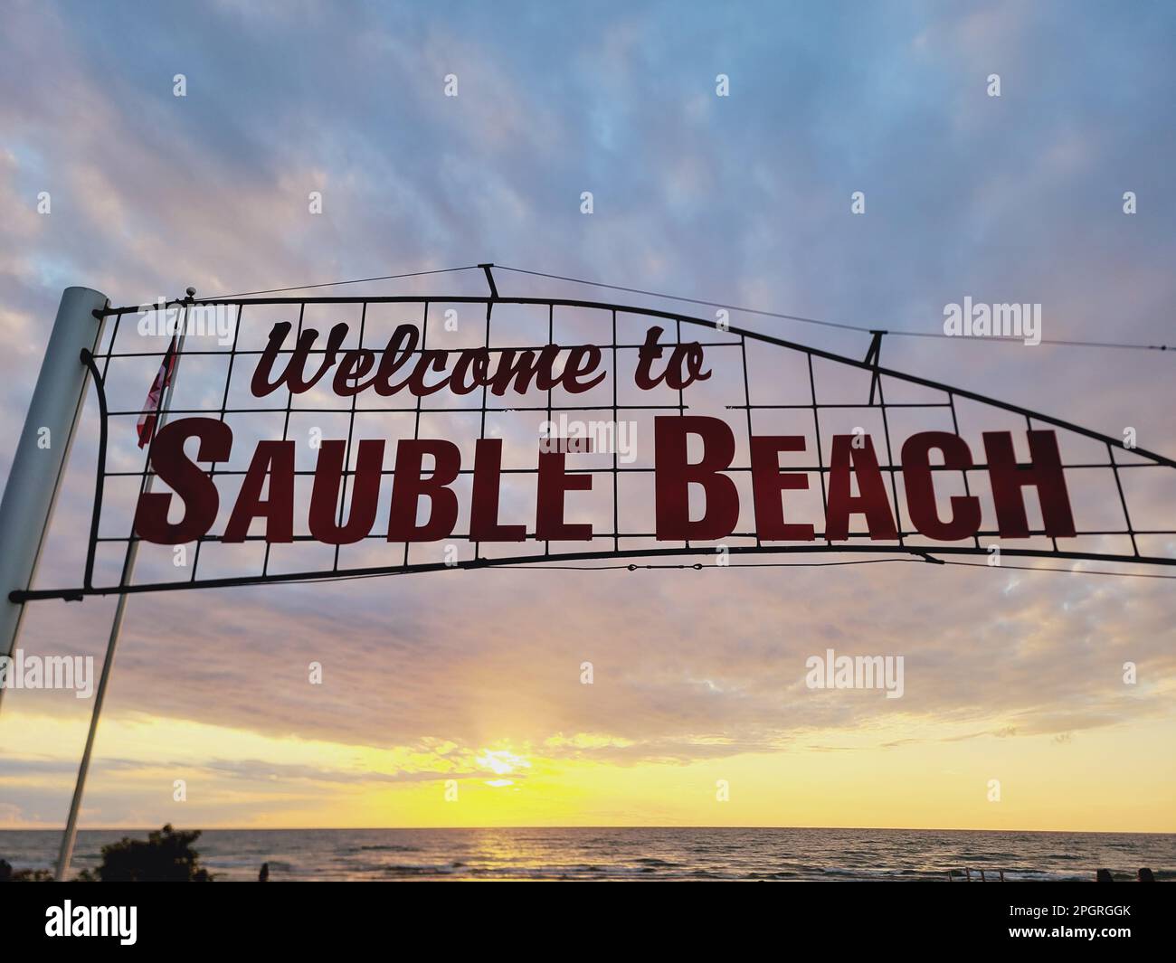 A welcome sign with red letters at the entrance to Sauble Beach with a ...