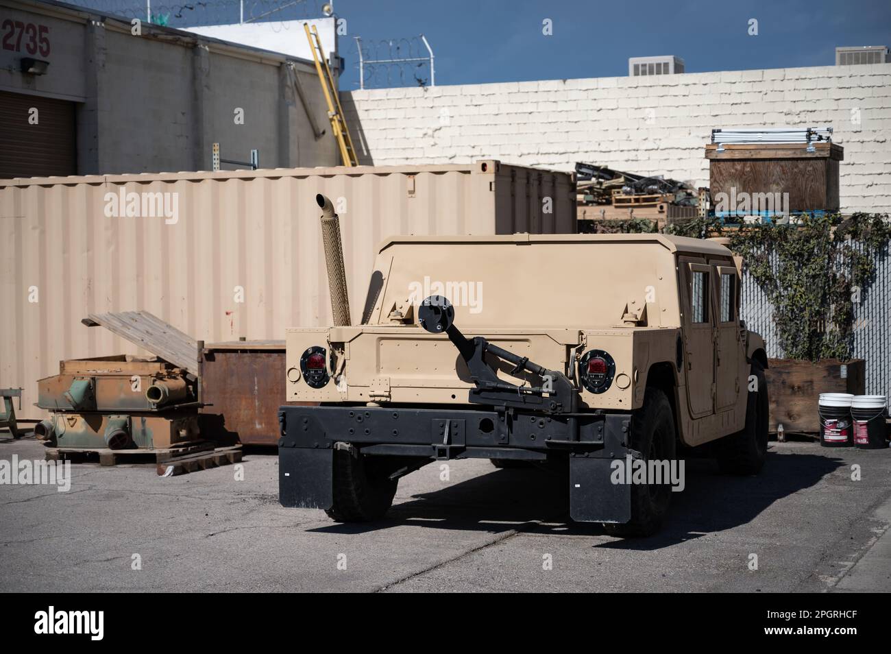 A desert-inspired camouflage colored Humvee SUV driving Stock Photo - Alamy