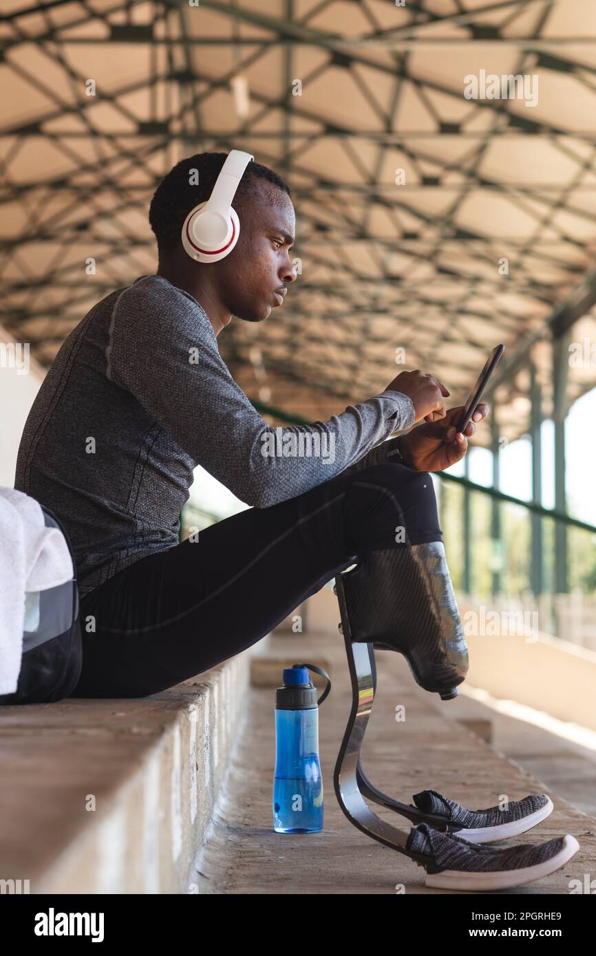 Fit, mixed race disabled male athlete at an outdoor sports stadium ...