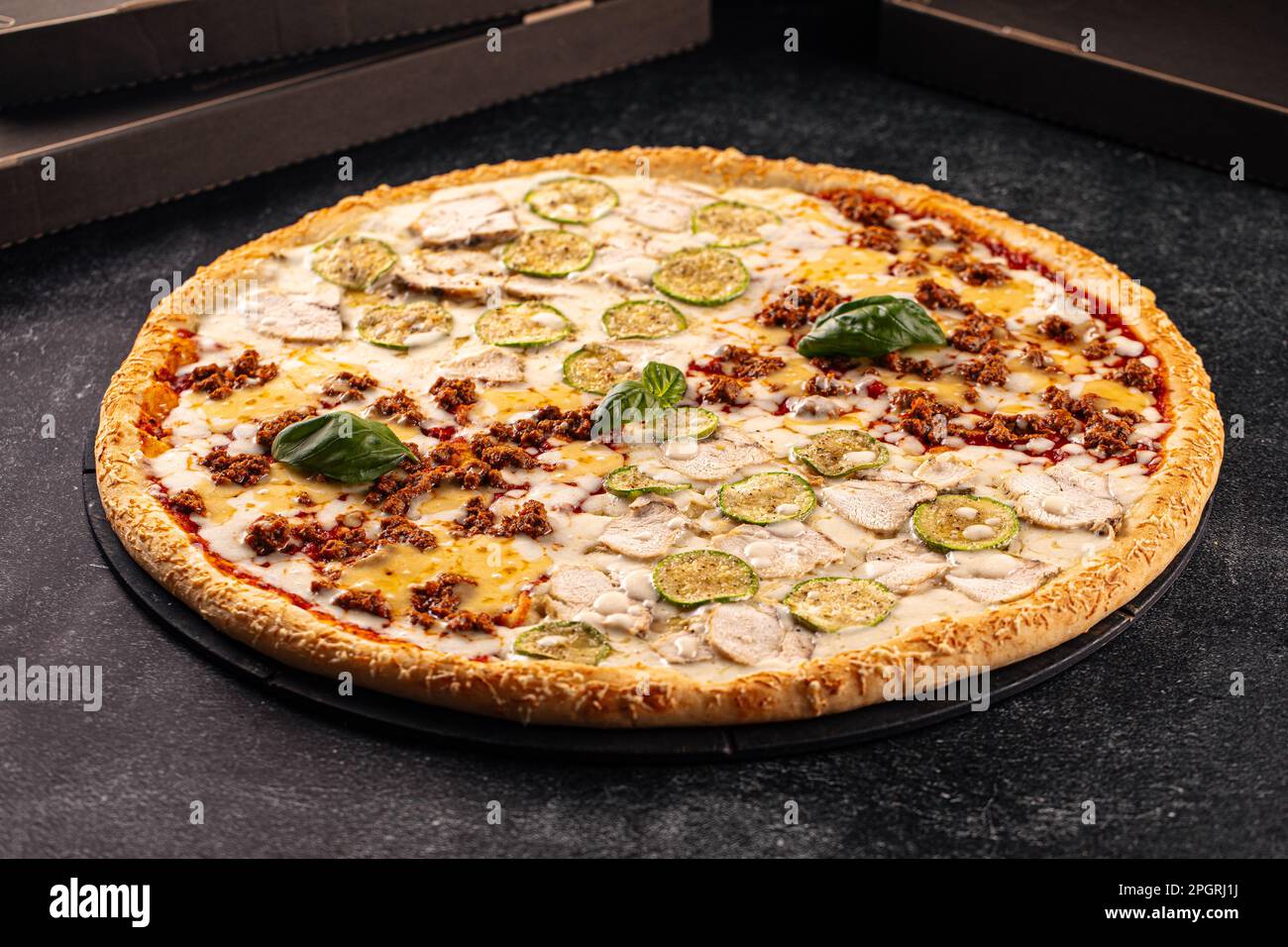 Big assorted pizza with variety of toppings Stock Photo - Alamy