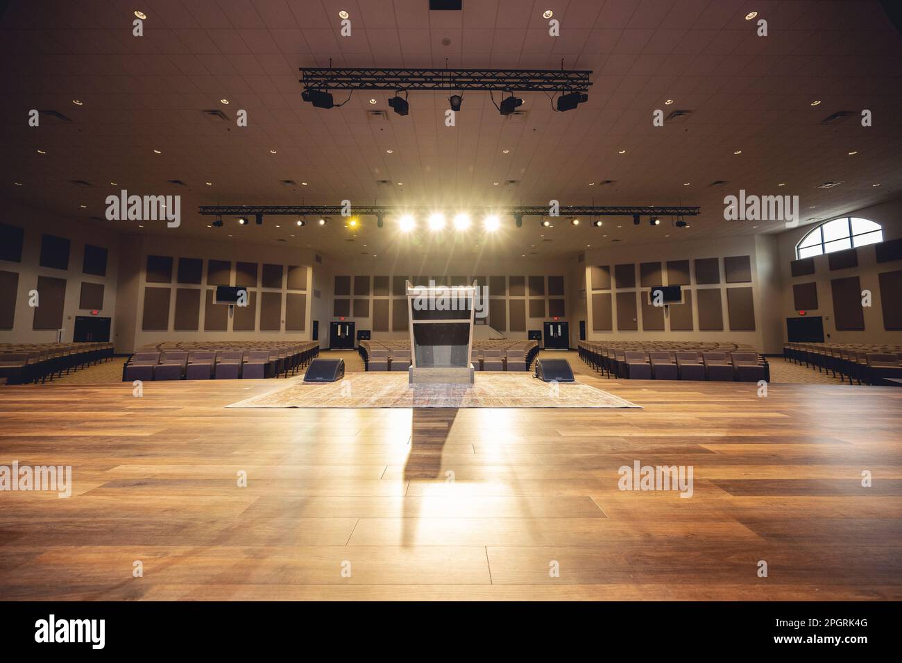 An illuminated empty hall with a stage and empty seats Stock Photo - Alamy