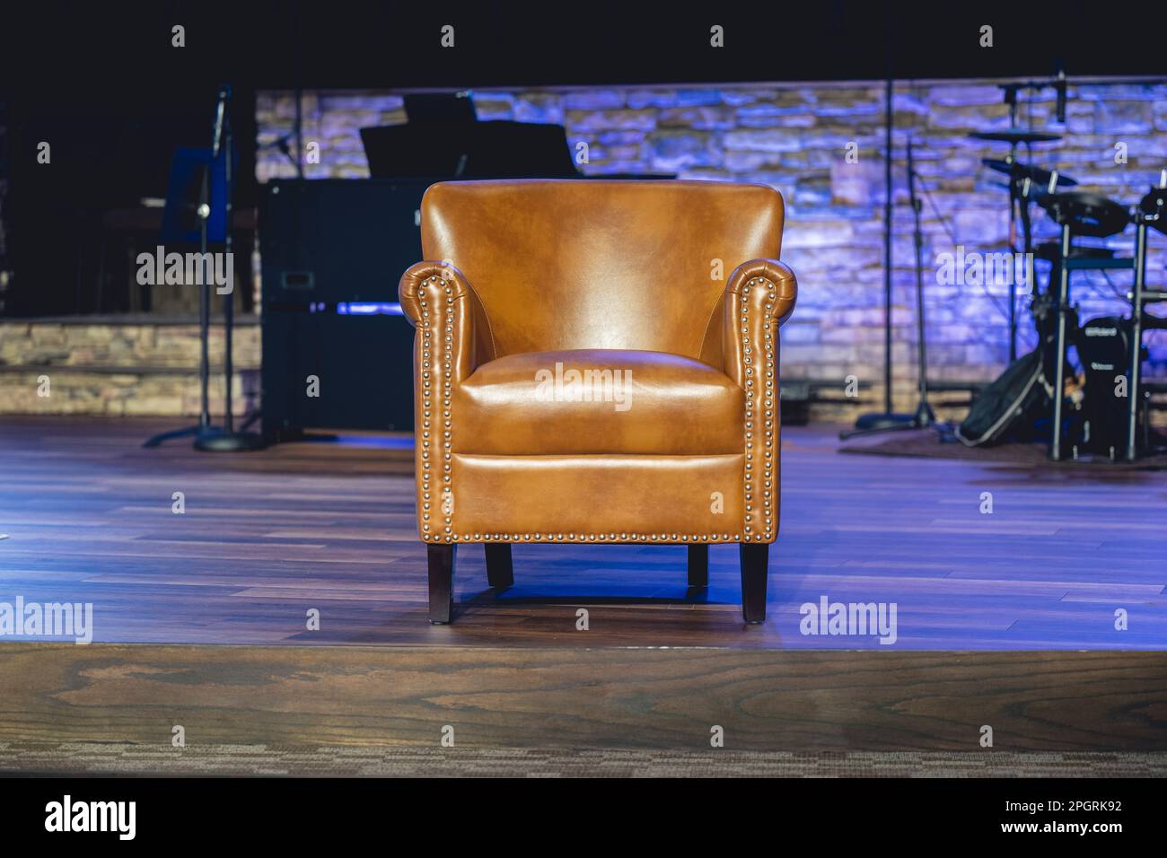 A stylish light brown leather armchair on the stage Stock Photo - Alamy