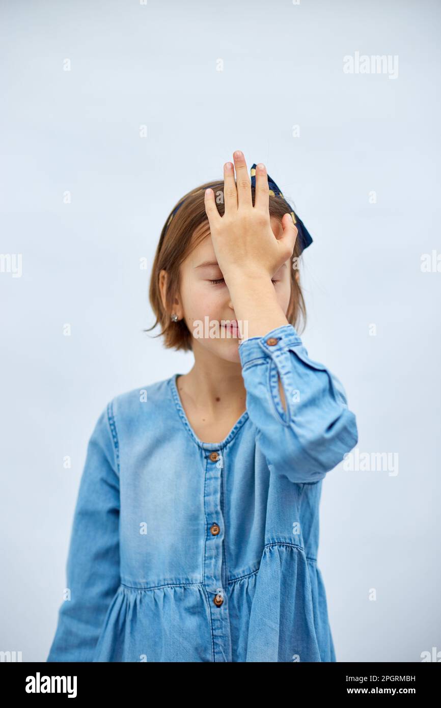 Teen girl child wearing jeans dress put hand on face facepalm in studio ...