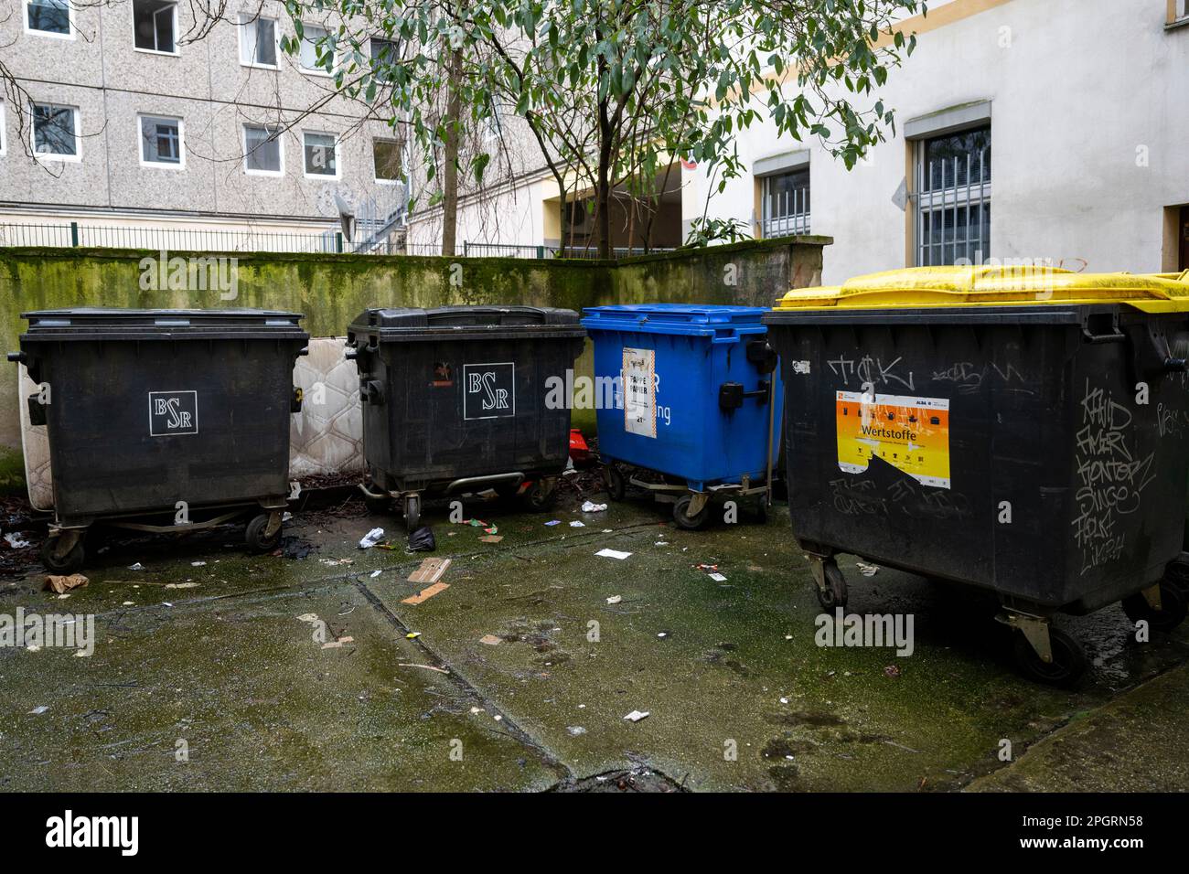 Berlin, Germany. 24th Mar, 2023. Garbage cans stand in a backyard. The ...