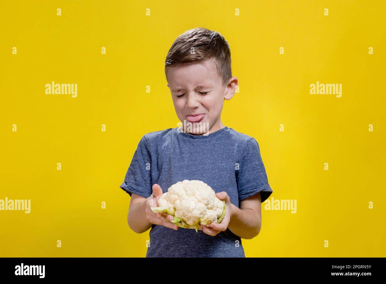 A charming little boy refusing to eat cauliflower. Healthy food Stock ...