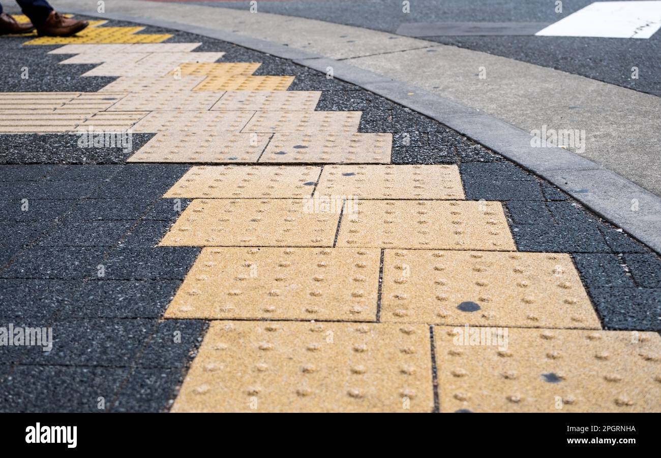 Japanese Yellow Tenji Blocks or tactile paving at a road crossing in ...
