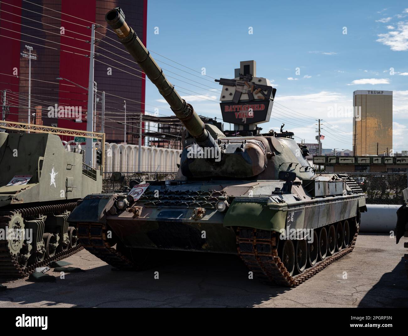 A vintage military vehicle parked in an urban parking lot, surrounded ...
