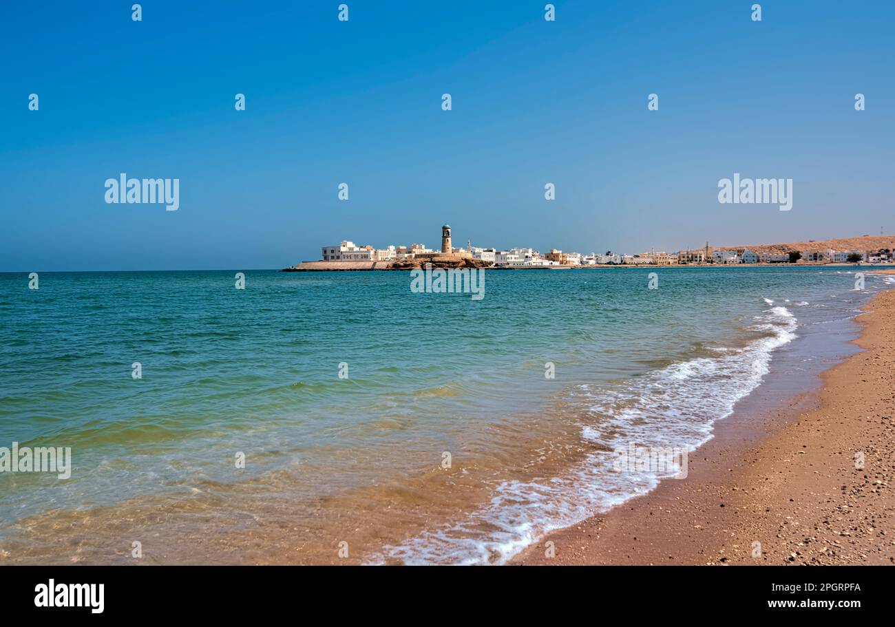 The Al Ayjah lighthouse and whitewashed village in Sur, Ash Sharqiyah ...
