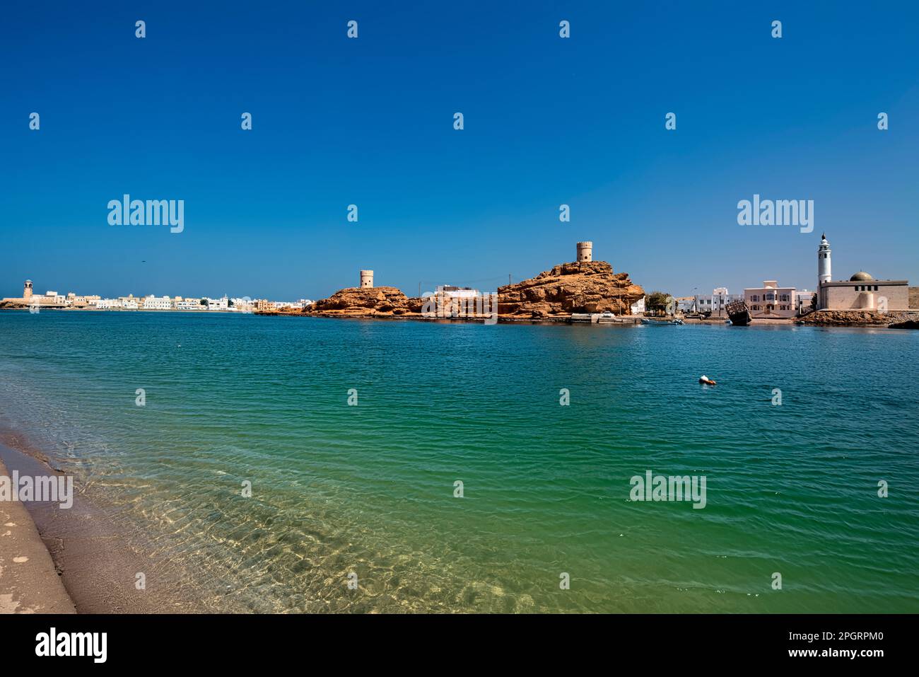 View of fort and castle ruins and the whitewashed coastal town of Al ...