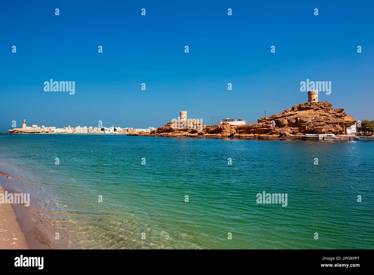 View of fort and castle ruins and the whitewashed coastal town of Al ...
