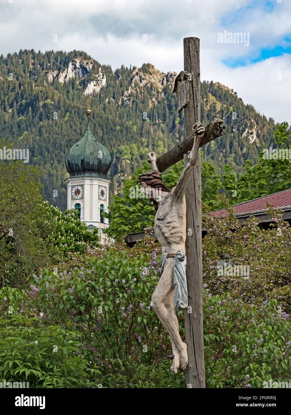 View of the steeple of the Catholic parish church of St. Peter and Paul and a crucifix in ...