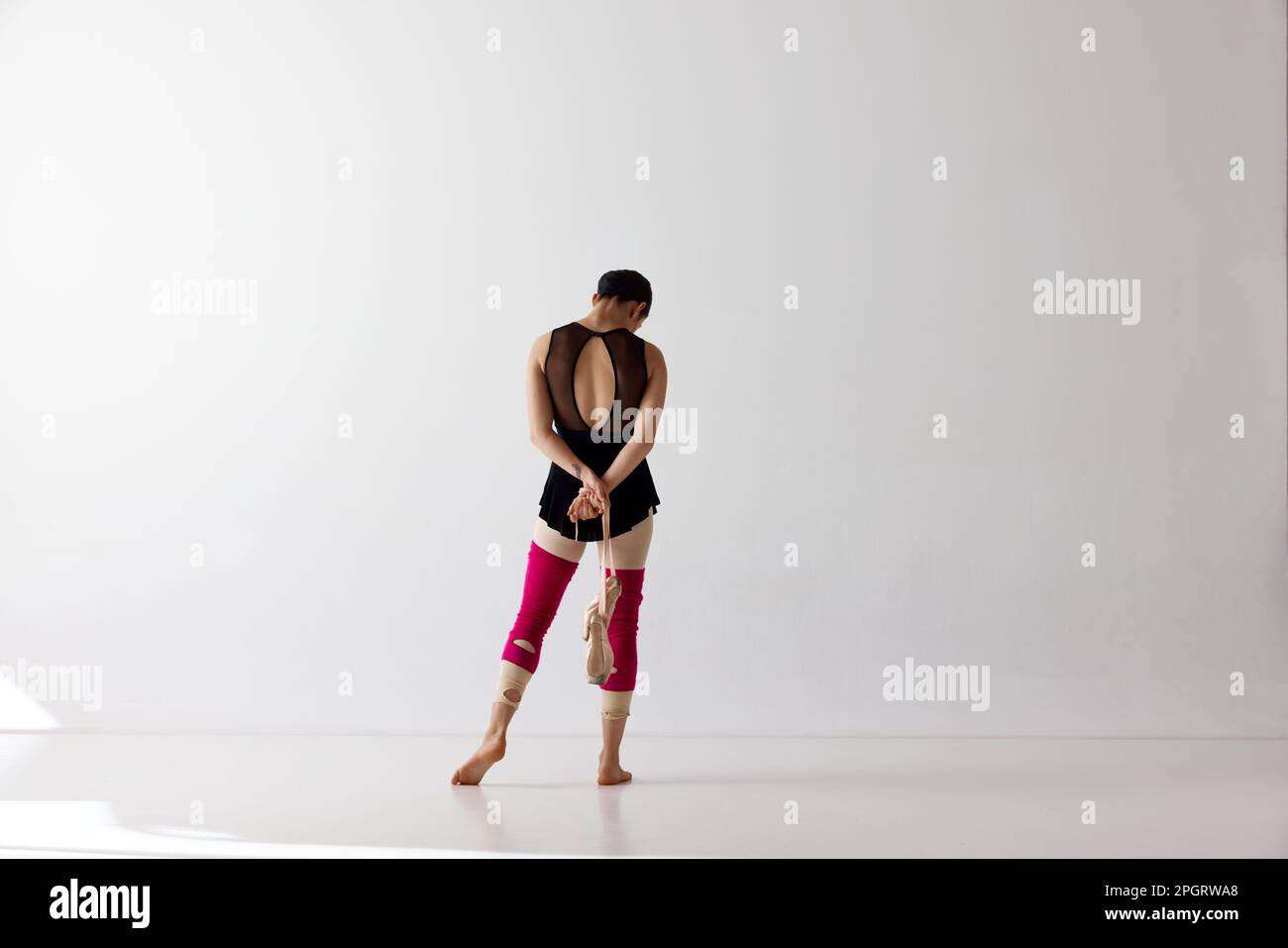 Back view. Graceful classical dance training over white background ...
