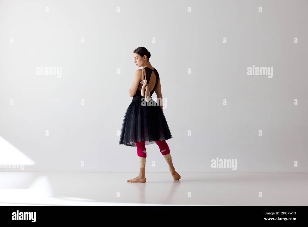 Side view. Young graceful female ballet dancer or classic ballerina ...