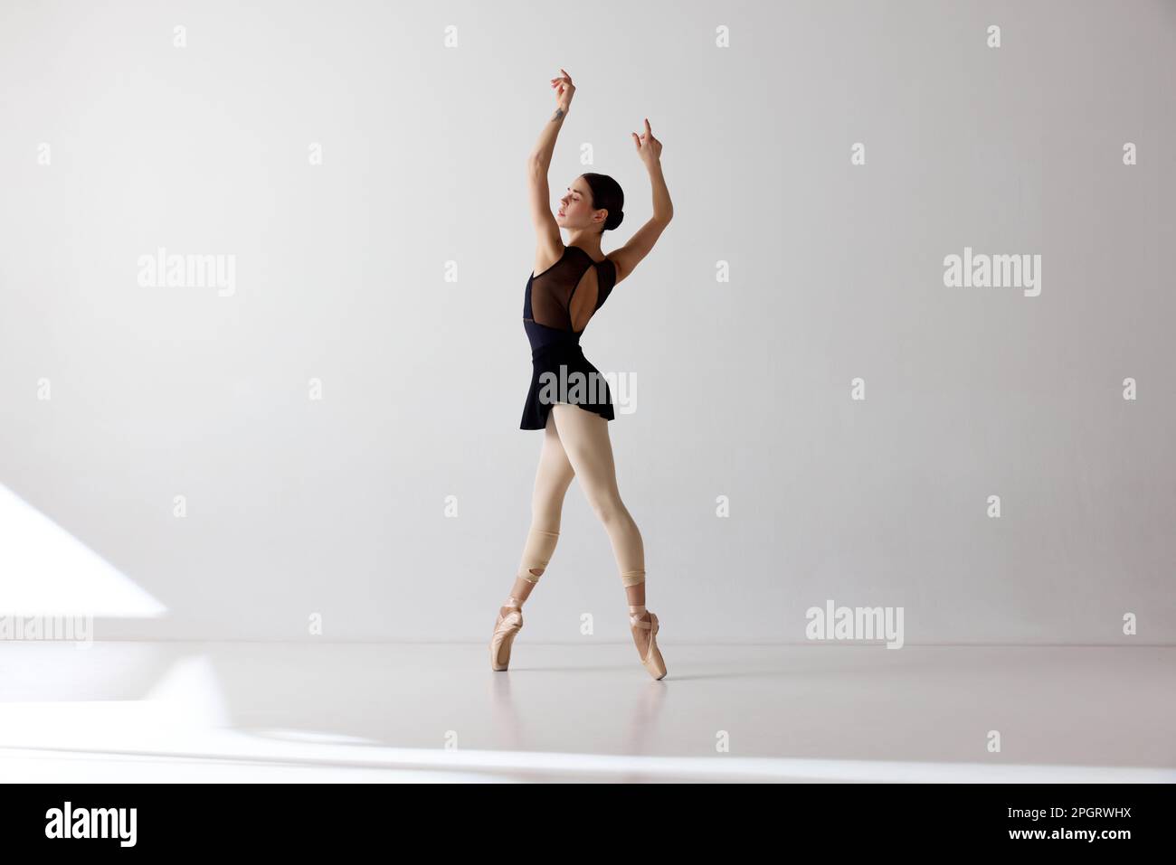 Portrait of tender young ballerina dancing, performing isolated over ...