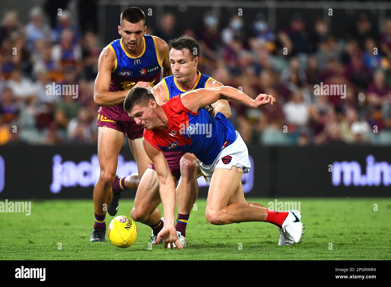 Judd McVee of the Demons competes with Lincoln McCarthy of the Lions ...