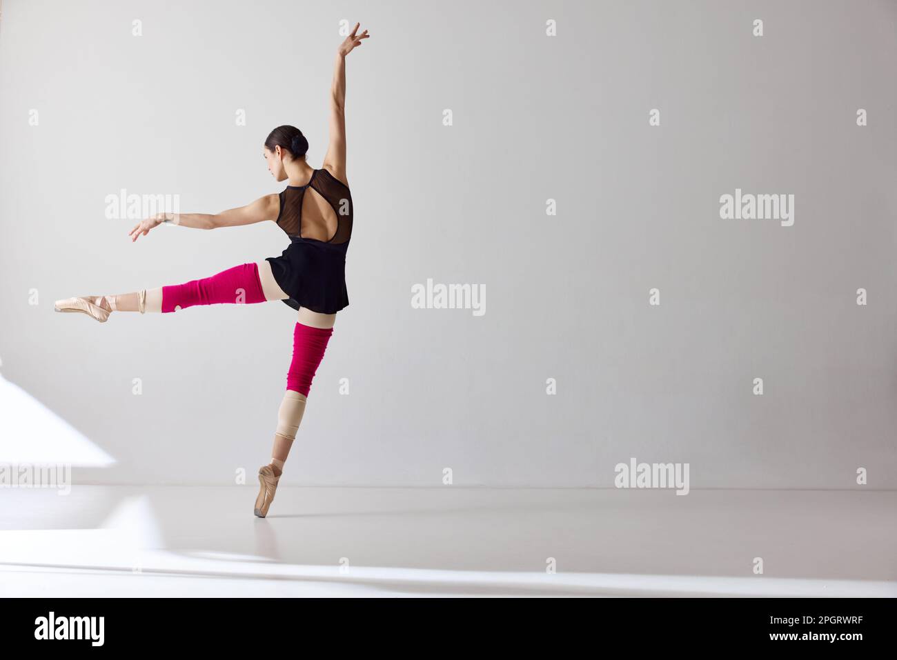 Back view. One beautiful ballerina wearing pointe shoes and ...
