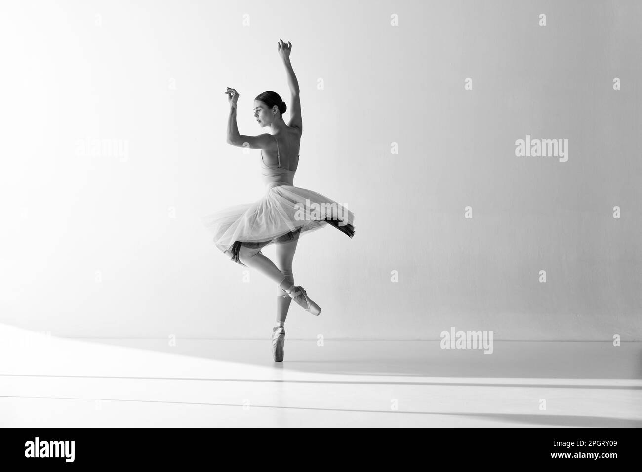 Monochrome Ballerina Wearing Tutu Poses In Motion Showing Ballet