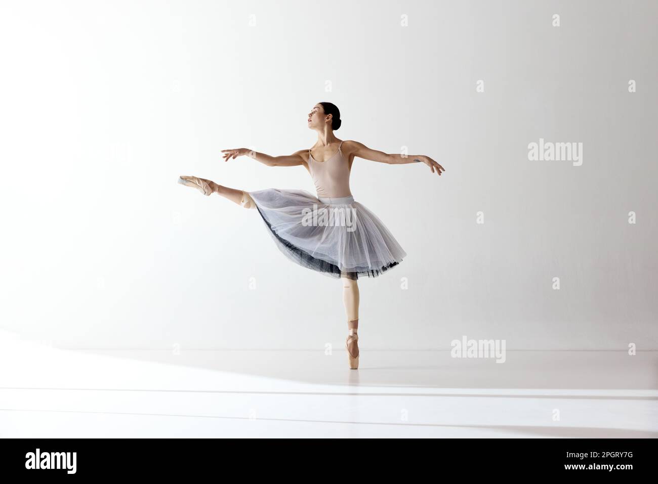 Young graceful woman ballet dancer dressed in professional outfit ...