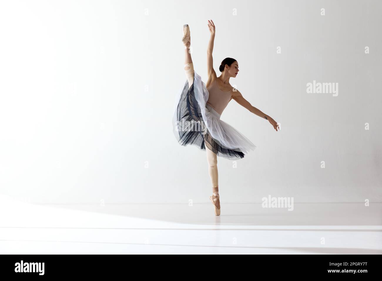 Young and incredibly beautiful ballerina is posing and dancing in a ...