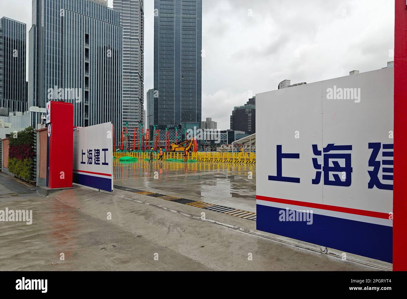 Several large construction machines are in place and some workers work ...