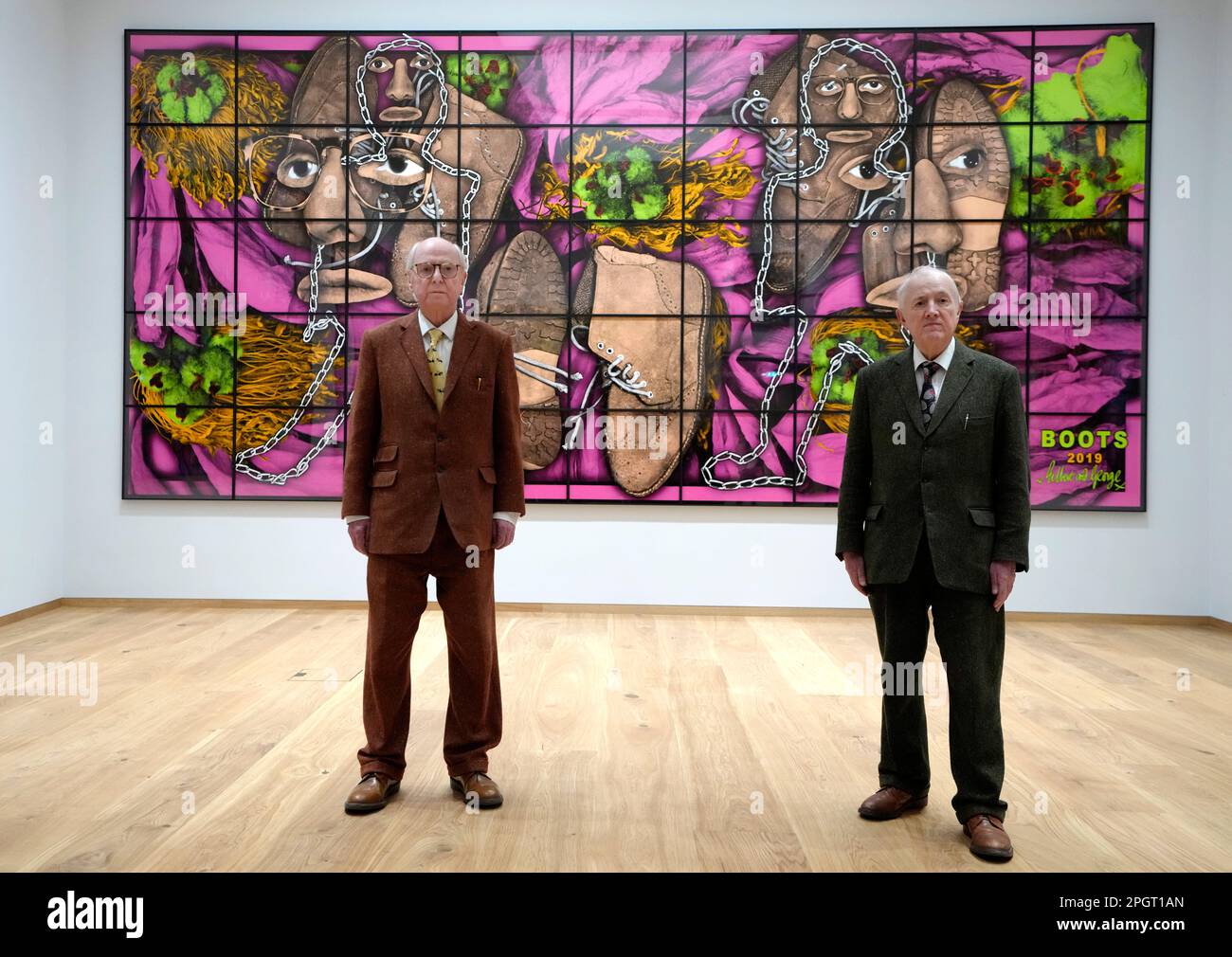 Artists Gilbert and George stand with their artwork called Boots in ...