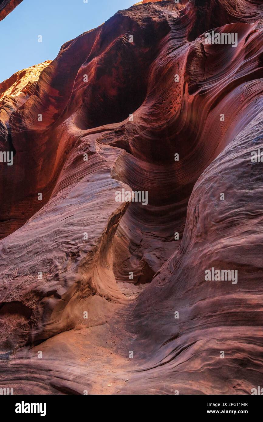 The red sandstone rocks at the Utah Canyons, with a blue sky and white ...