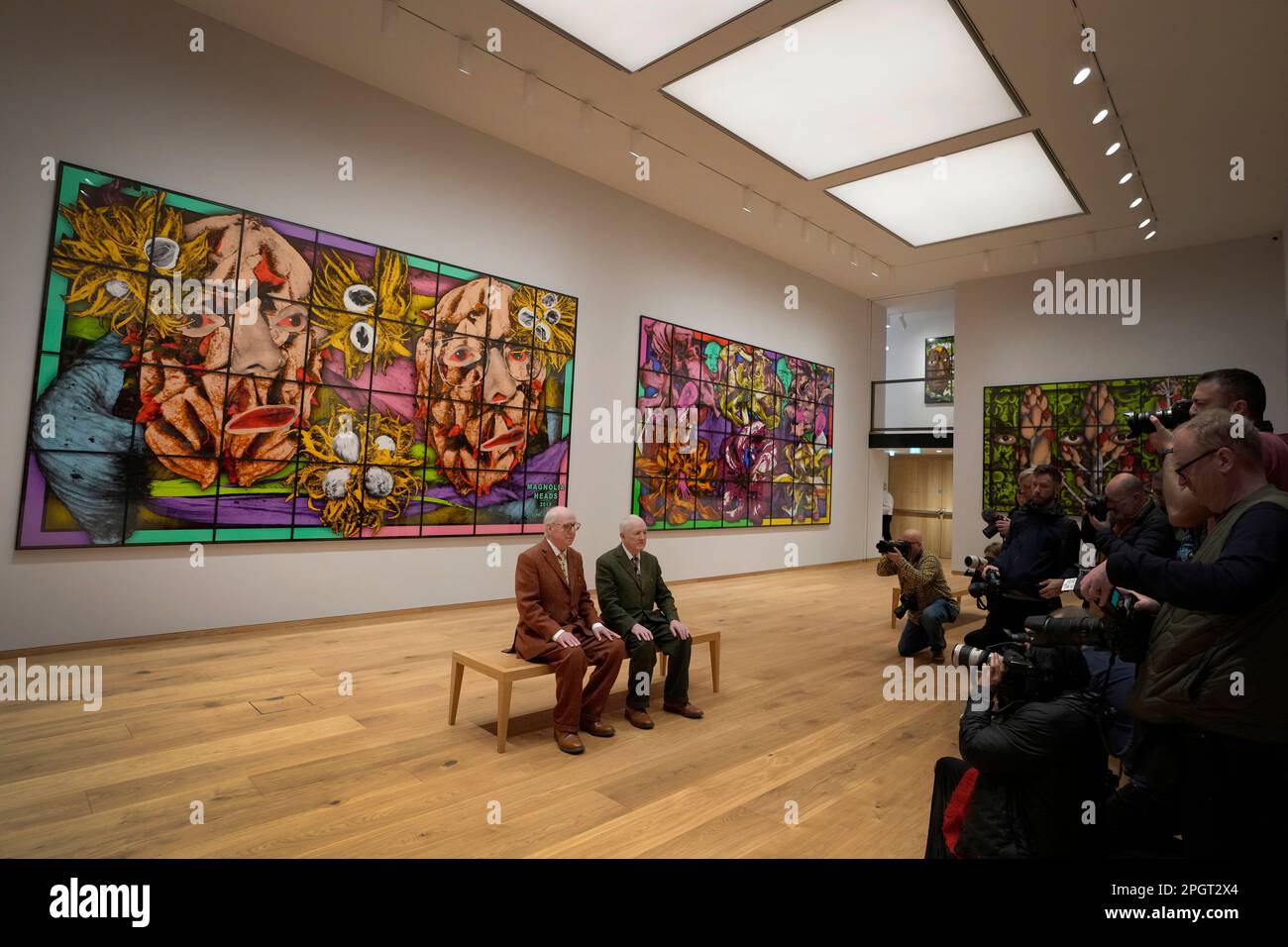 Gilbert and George are photographed with their artwork in their ...