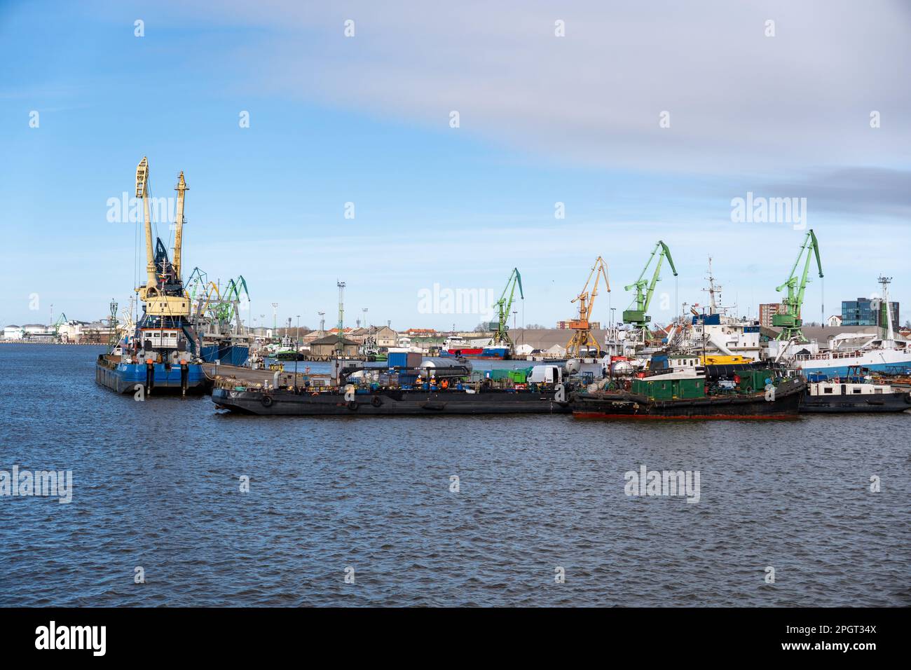 An aerial view of a busy industrial port, featuring numerous ships ...