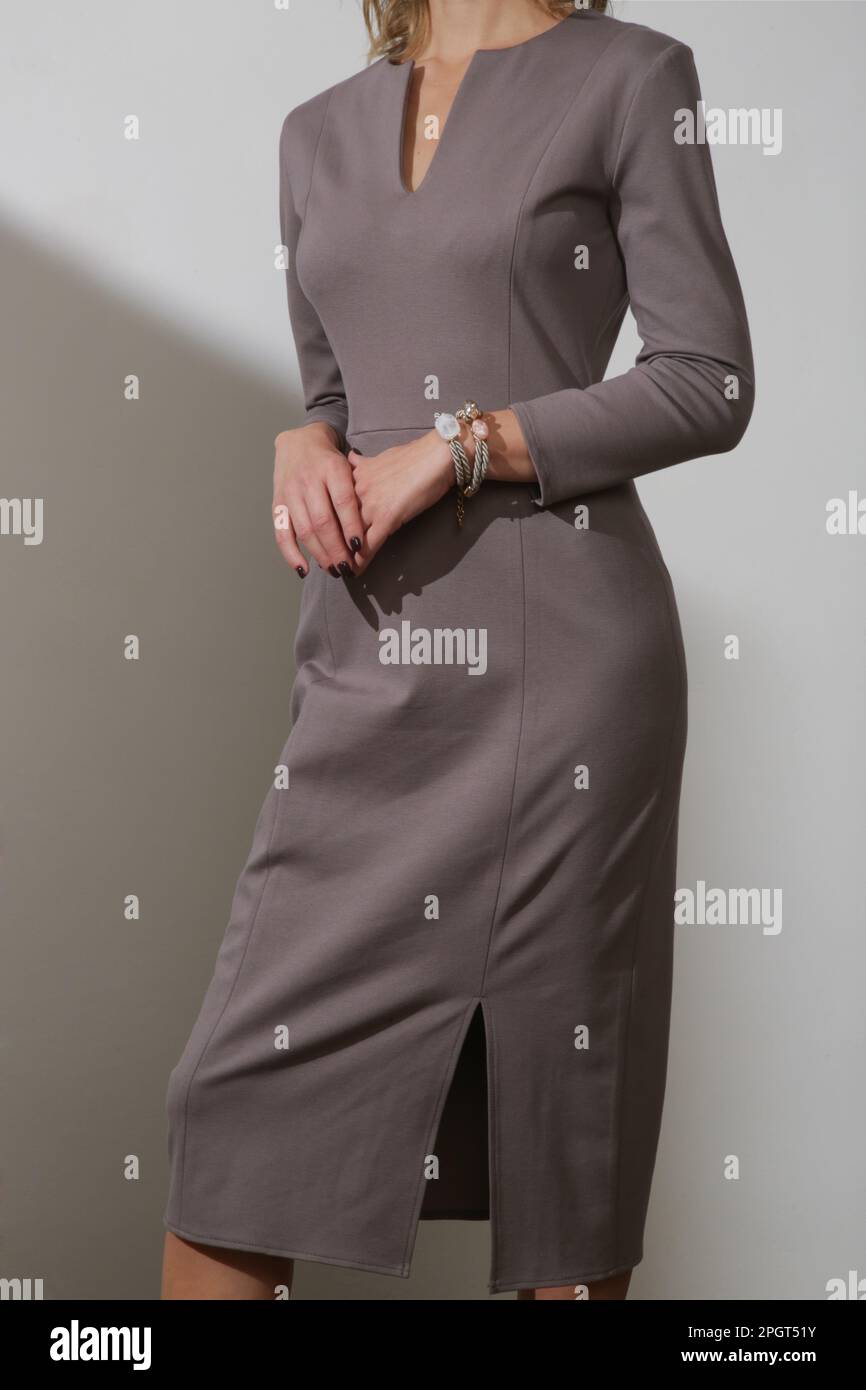 Serie of studio photos of young female model in midi elastic latte ...