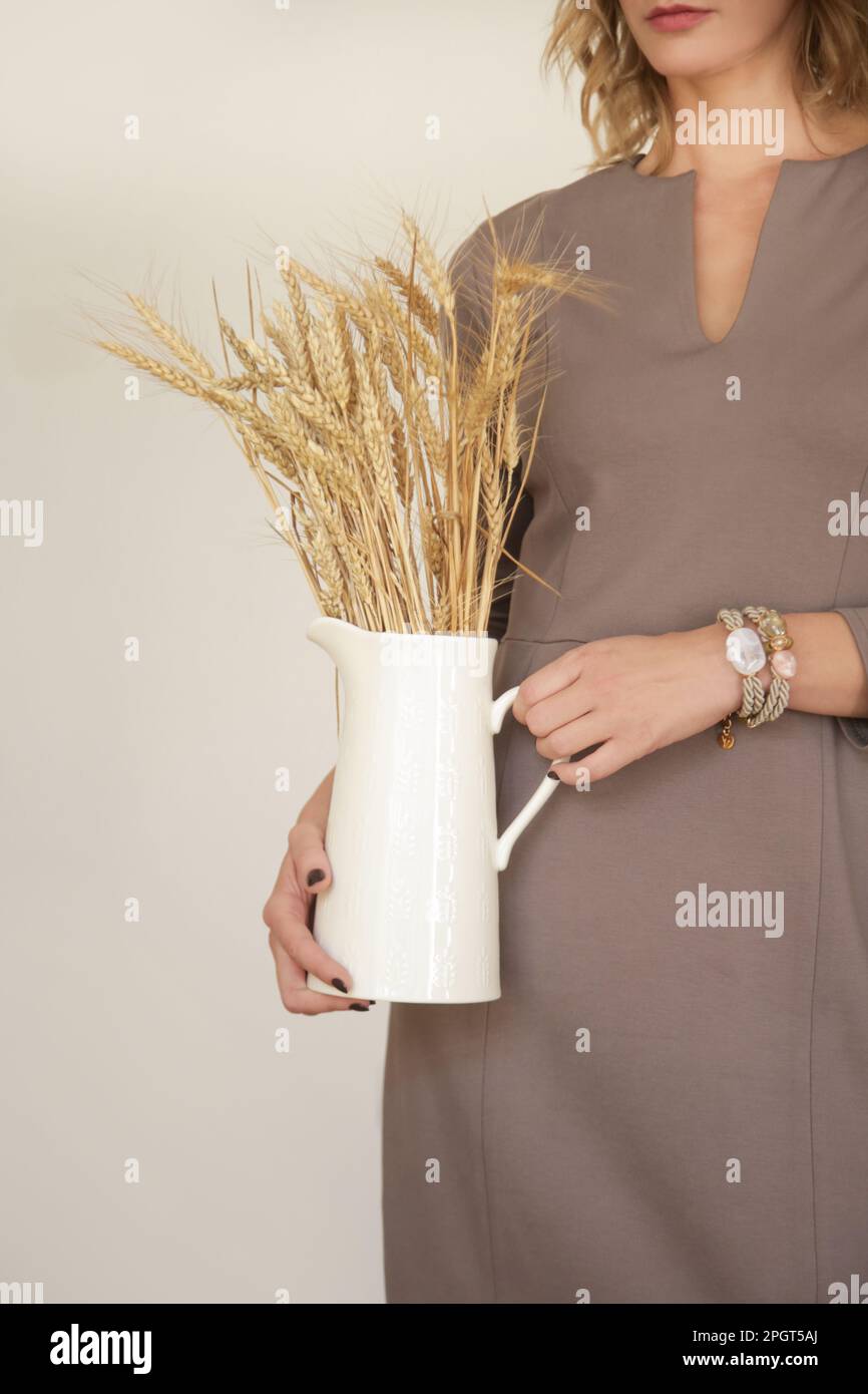 Serie of studio photos of young female model in midi elastic latte ...